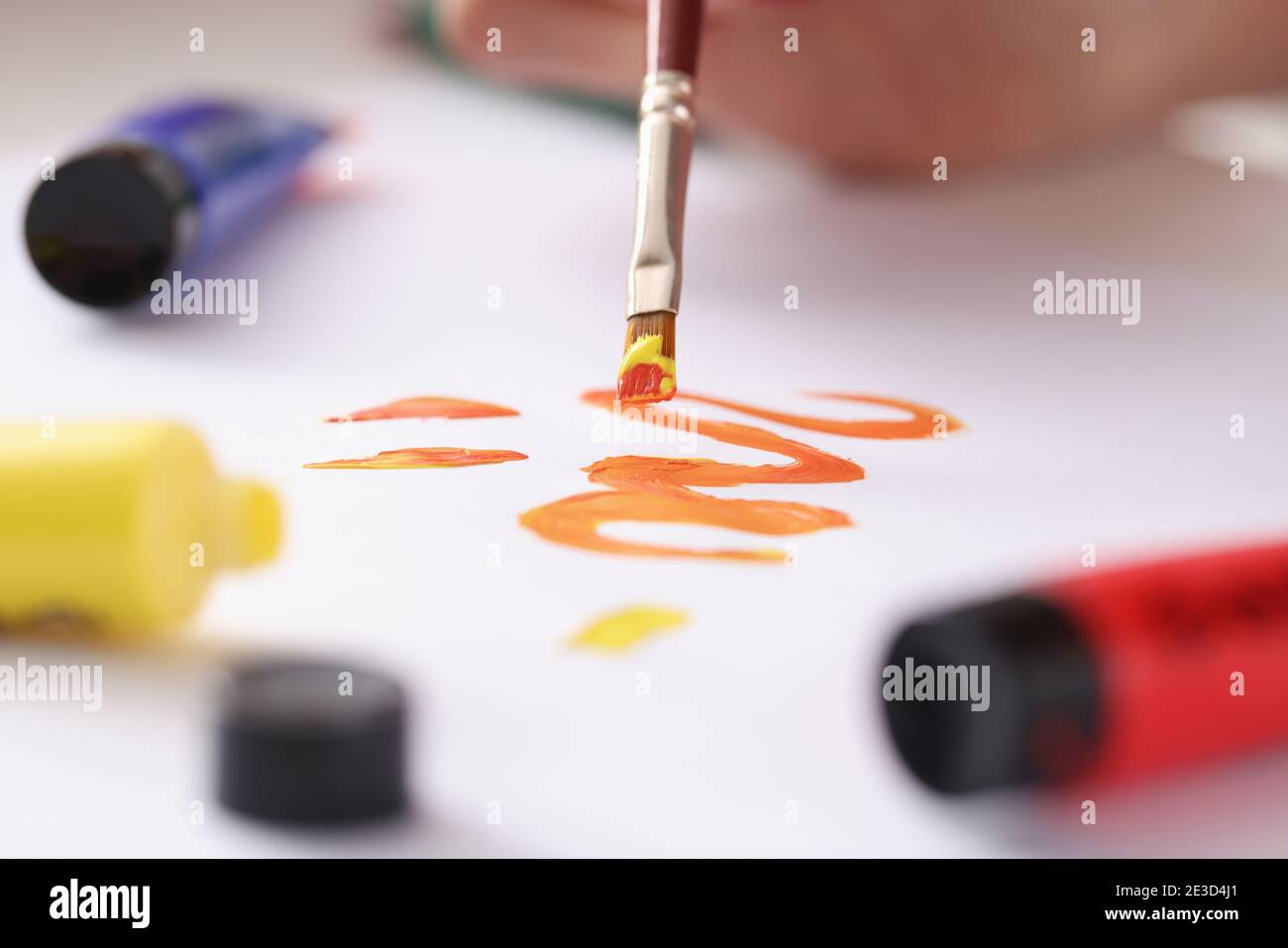 Draw drawing on sheet with brush closeup Stock Photo - Alamy