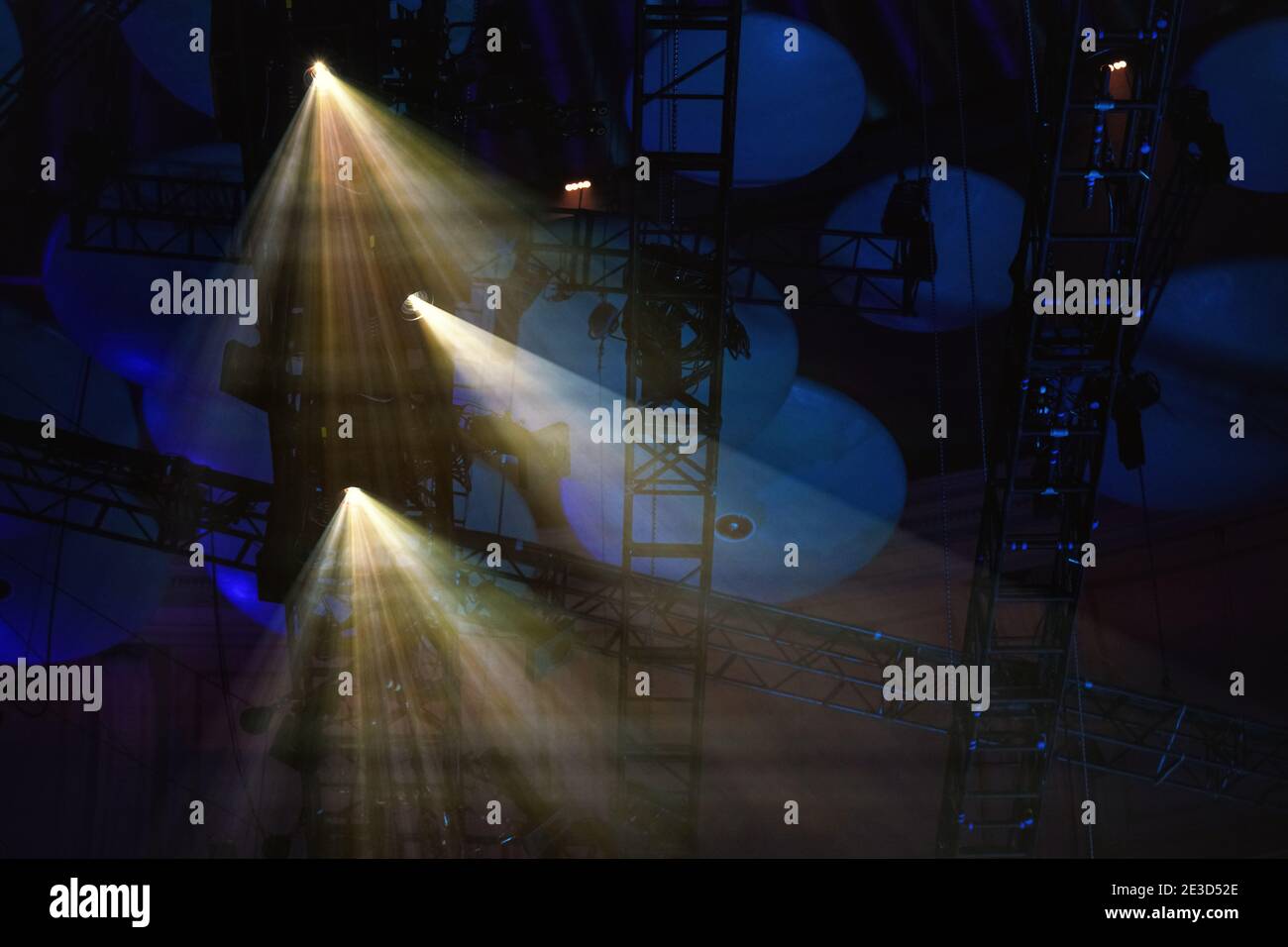 Reflector lights shining through smoke on theatre roof before ...