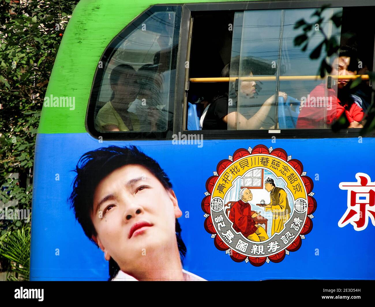 Passenger looks out of the rear of a bus in Shenyang, China Stock Photo ...