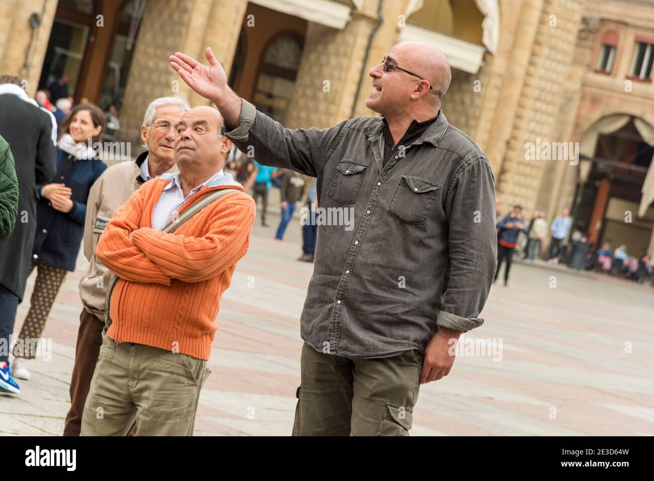 Men talking and debating using hand gestures in the Piazza Maggiore in ...