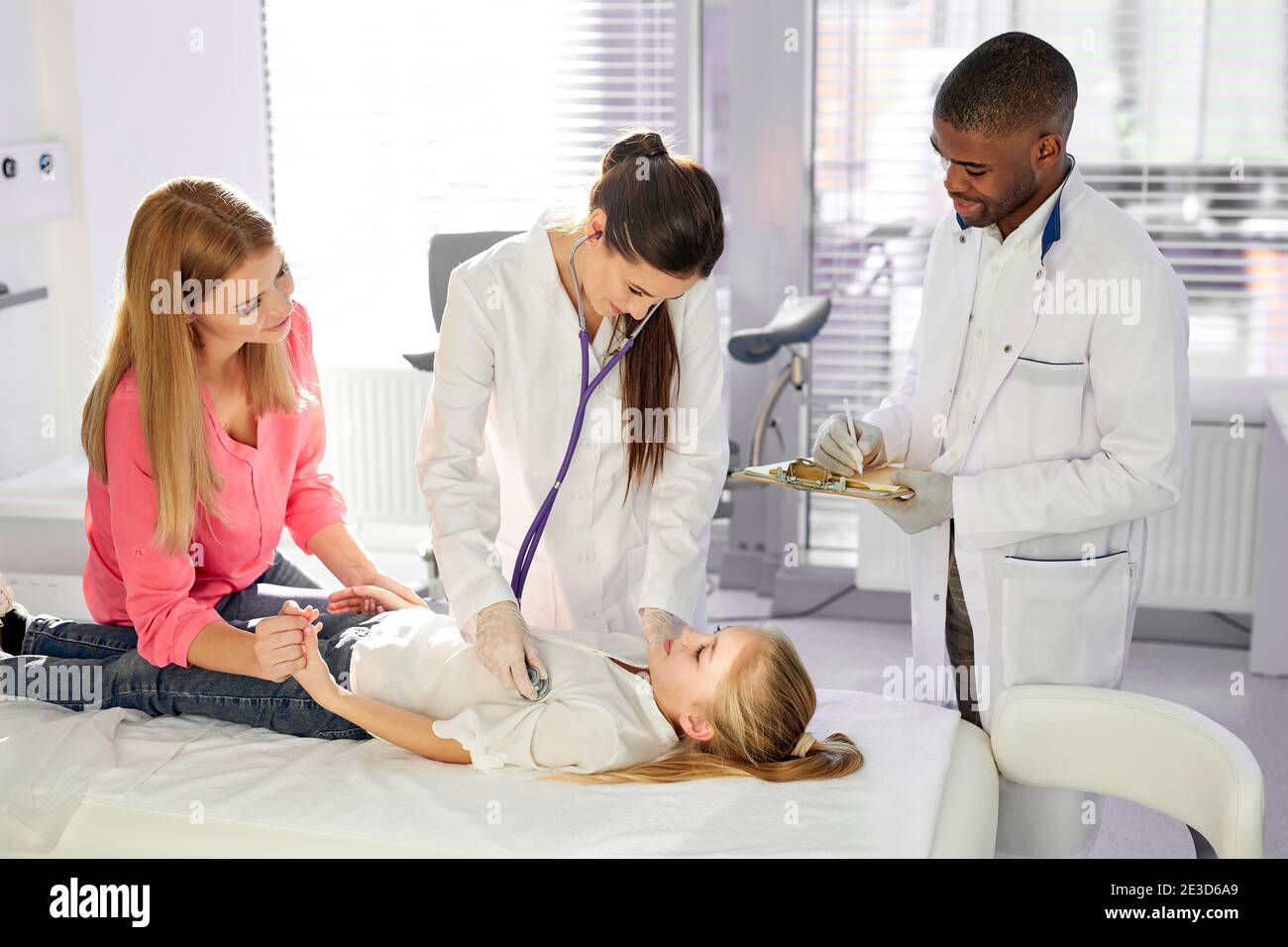 nice pediatricians working with children patients, check the health of ...