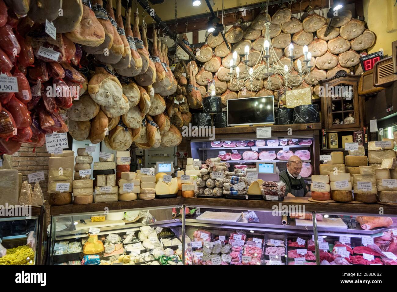 Cheese and parma ham on display in a delicatessen shop in Bologna Italy ...