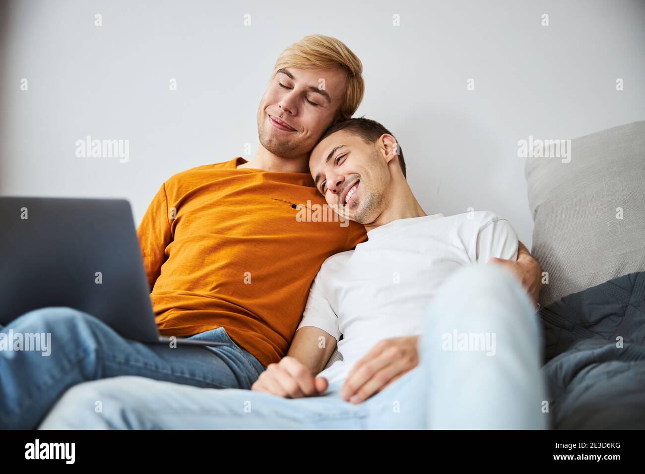 Happy gay couple cuddling hi-res stock photography and images - Alamy