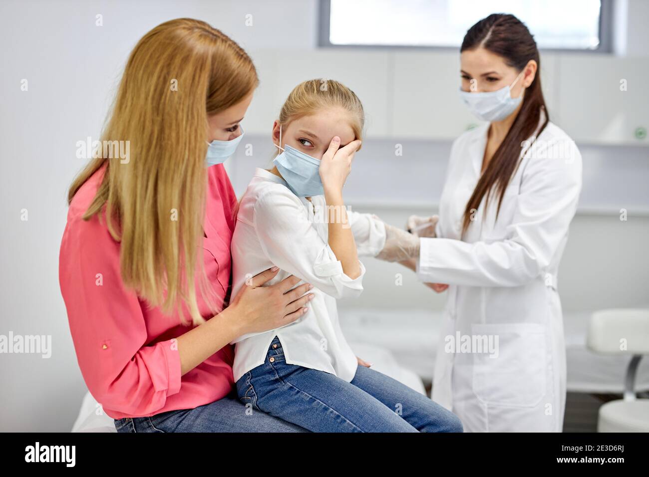 female doctor taking blood sample test of a little girl in the clinic ...