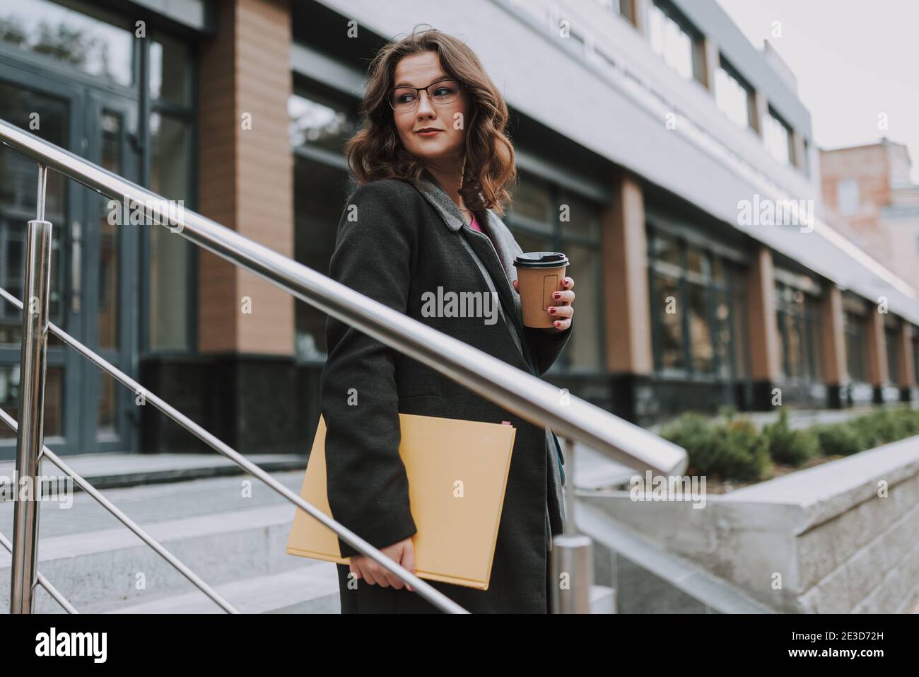 Woman walking downstairs hi-res stock photography and images - Alamy
