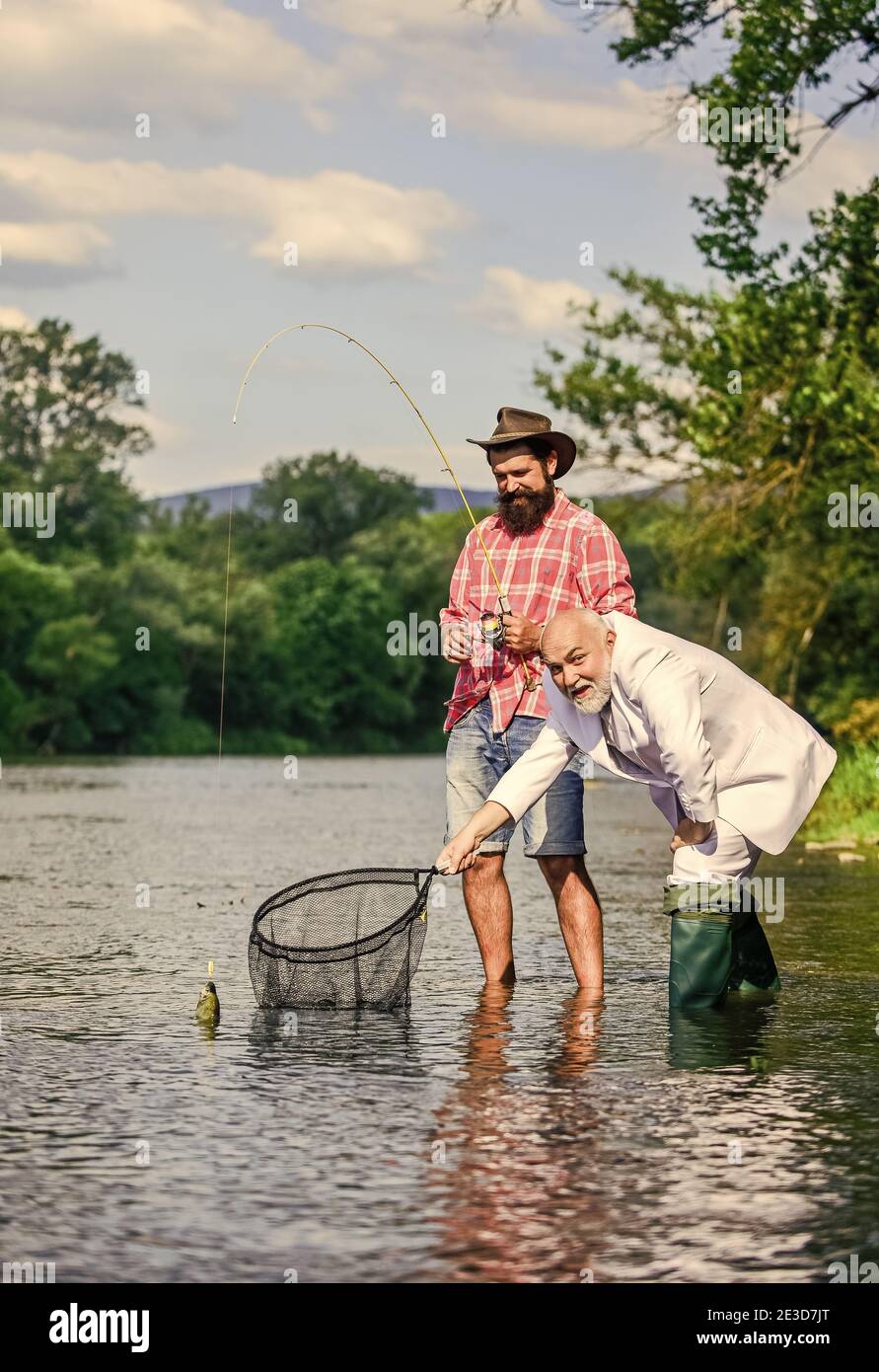 Family traditions. Two male friends fishing together. happy fishermen ...