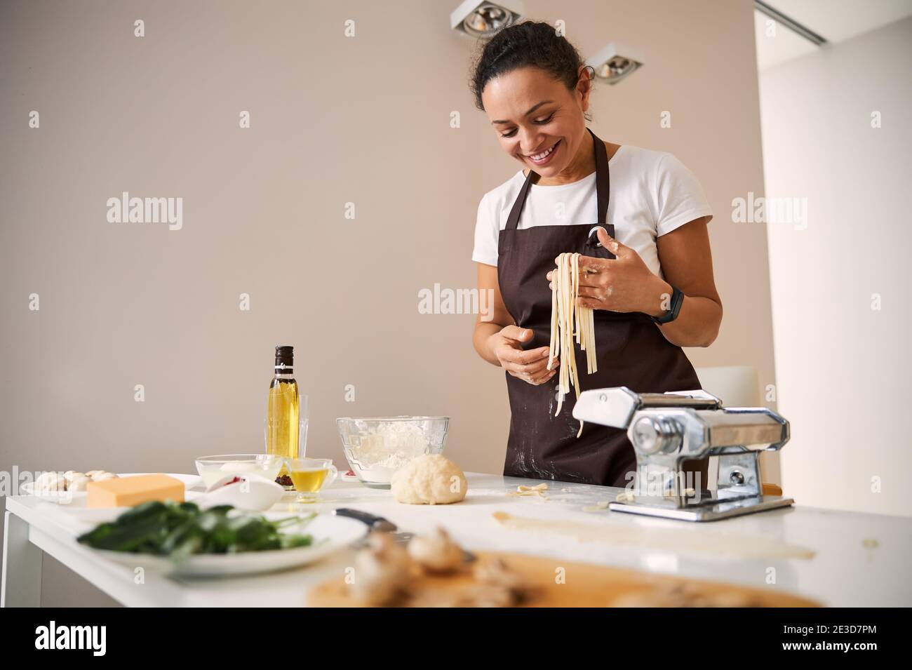 Happy lady enjoying the process of cooking at home Stock Photo - Alamy
