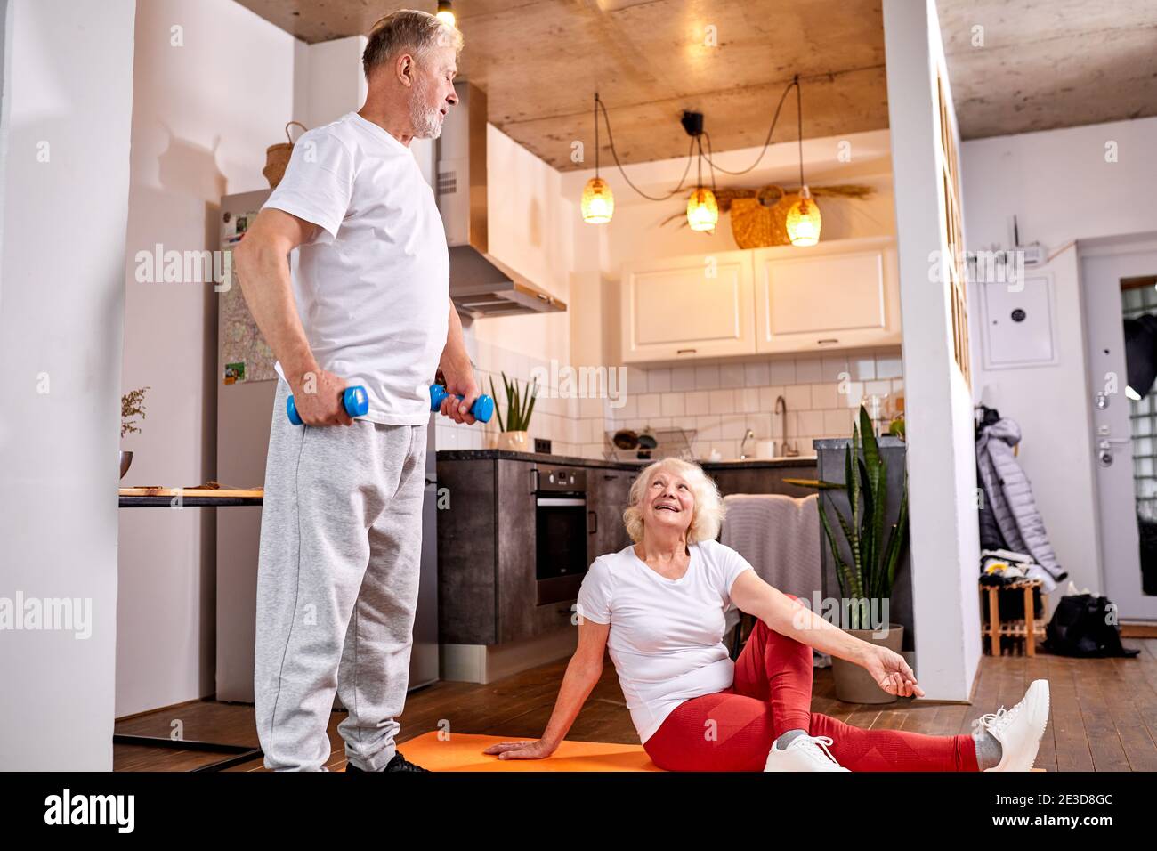 senior couple do exercises at home together, yoga and workout with ...