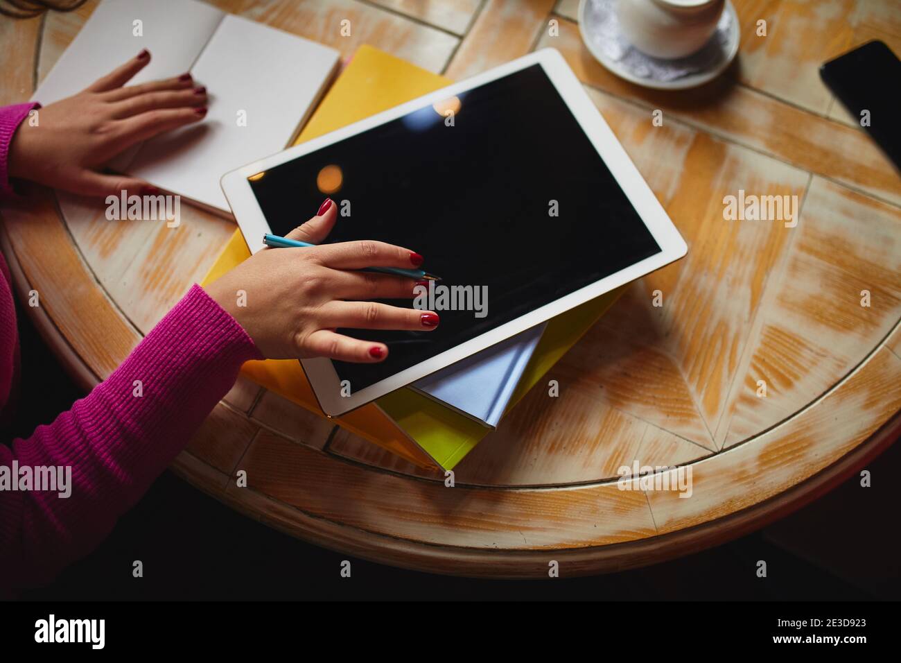 Top view of female typing on digital tablet while touching touchscreen ...
