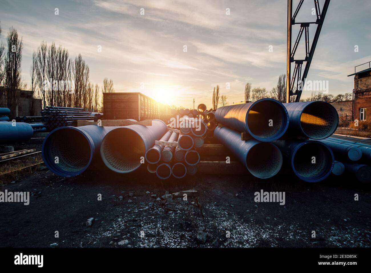 Stack of cast iron pipes in loading area waiting for transportation ...