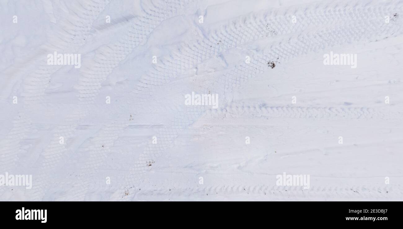 panorama view from above on texture of snow covered road with car tire ...