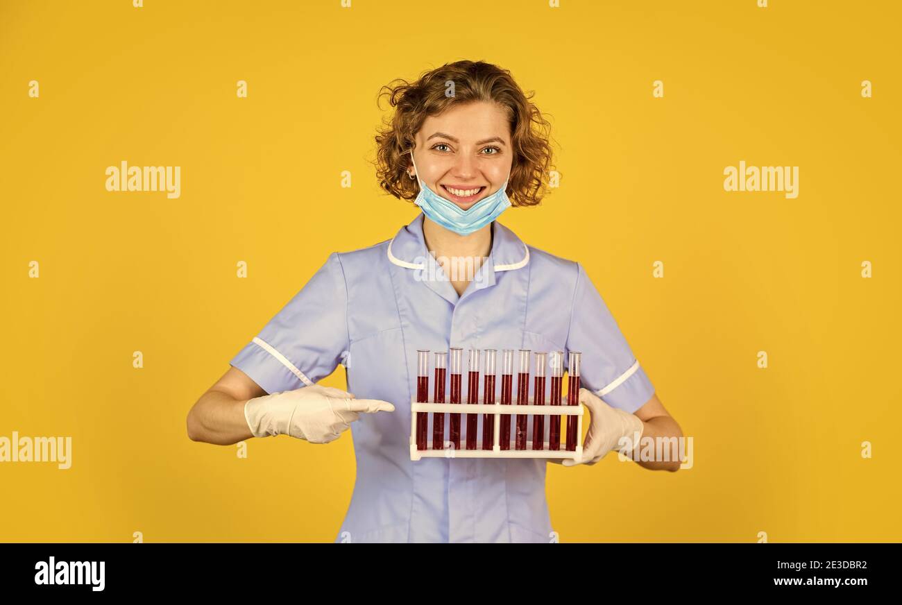 equipment in the lab. scientist in face mask and gloves holding test ...