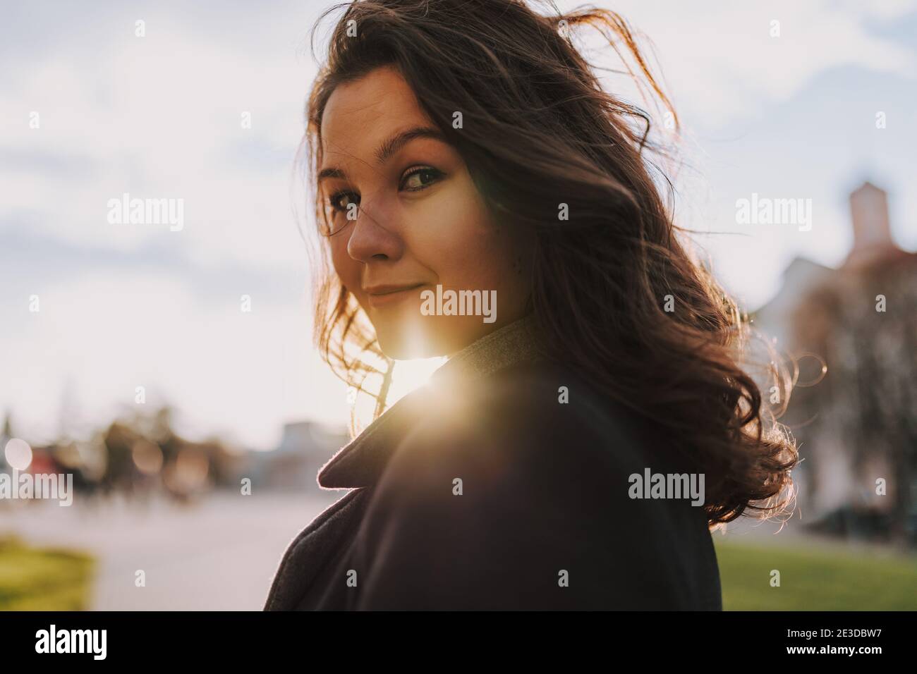 Pretty smiling lady enjoying the walk in the city while posing at ...