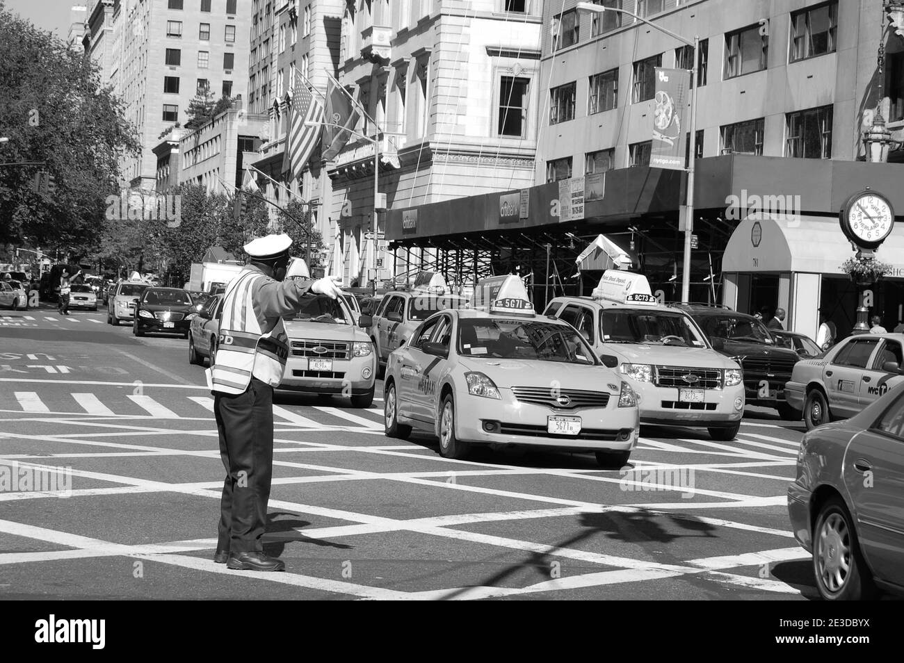New York USA traffic warden policeman directing traffic cars hat taxis ...