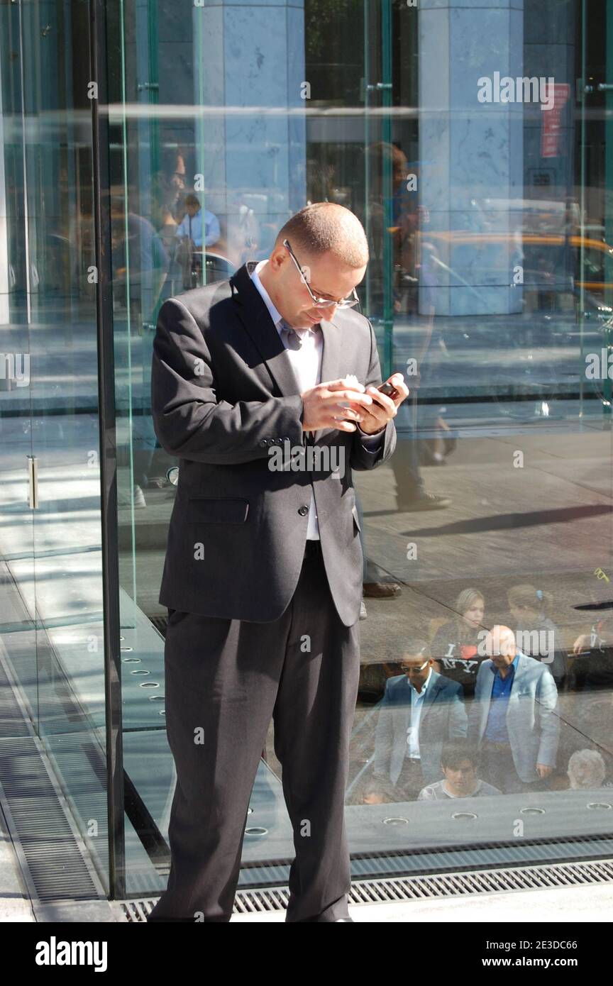 Man outside the apple shop in New York USA man on phone with glasses ...