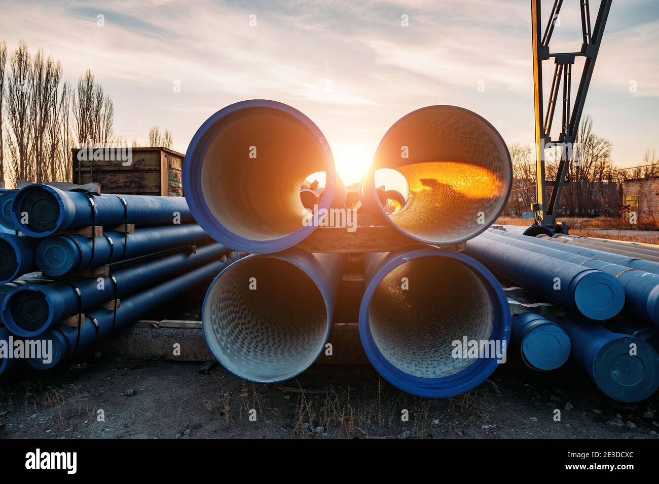 Stack of cast iron pipes in loading area waiting for transportation ...