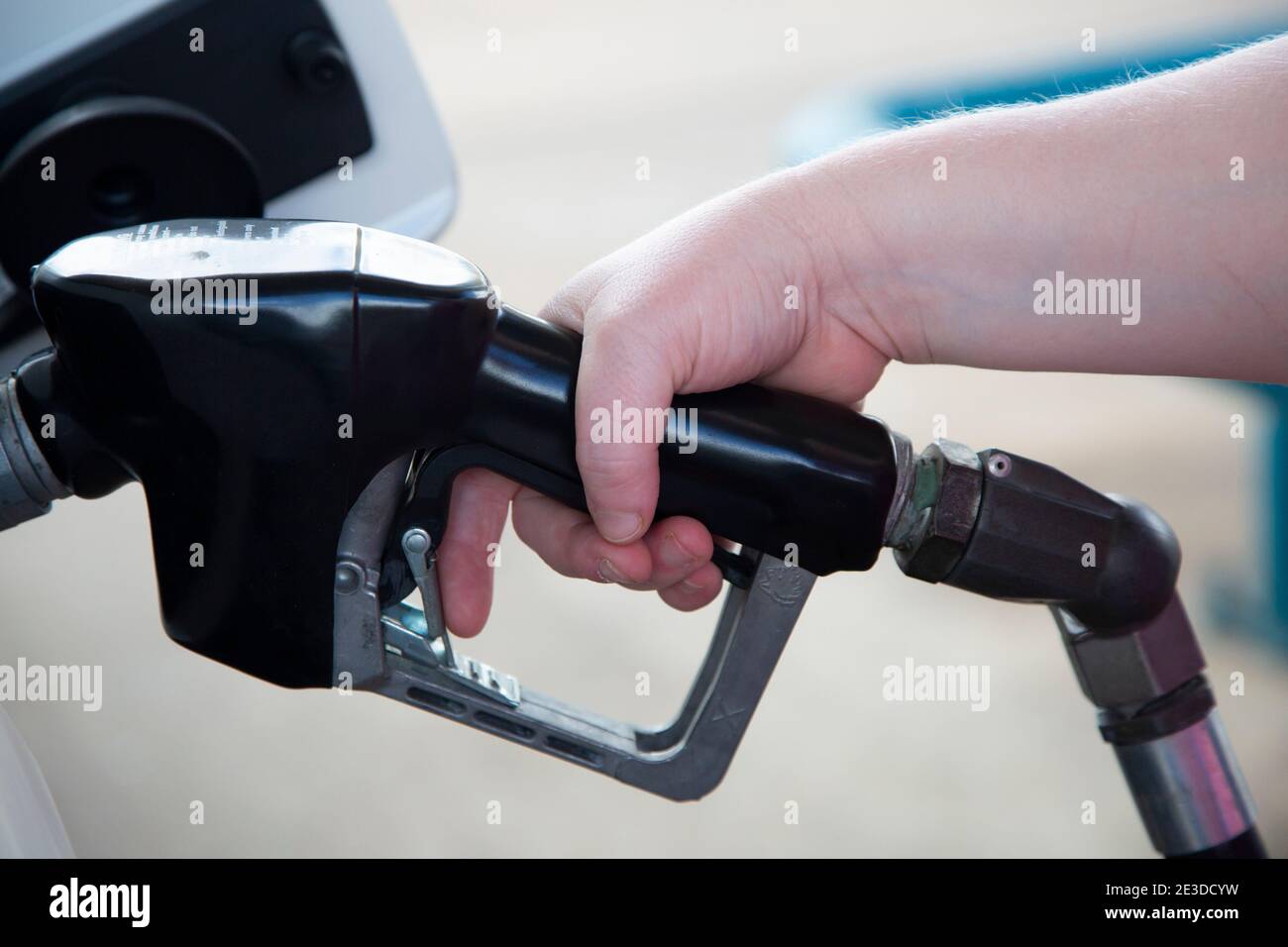 Woman's hand pushing a generic gas pump handle Stock Photo - Alamy