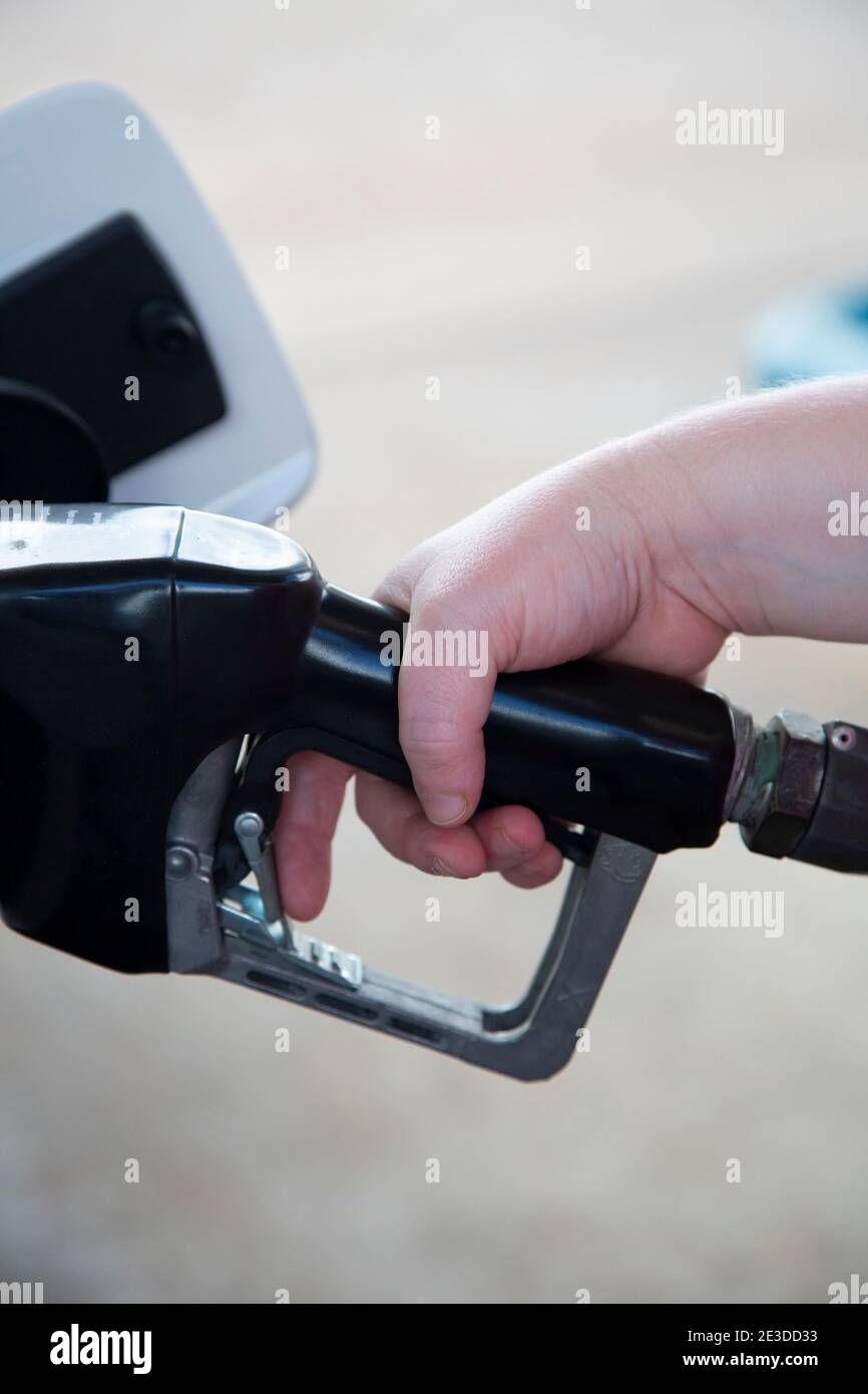 Woman's hand pushing a generic gas pump handle Stock Photo - Alamy