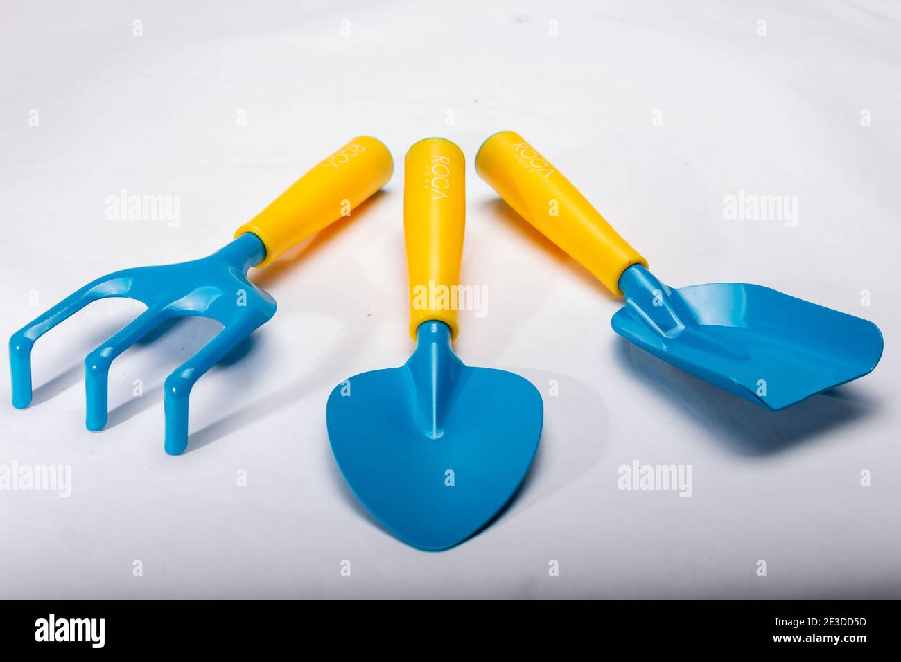 Closeup shot of plastic toy gardening tools on a white surface Stock ...