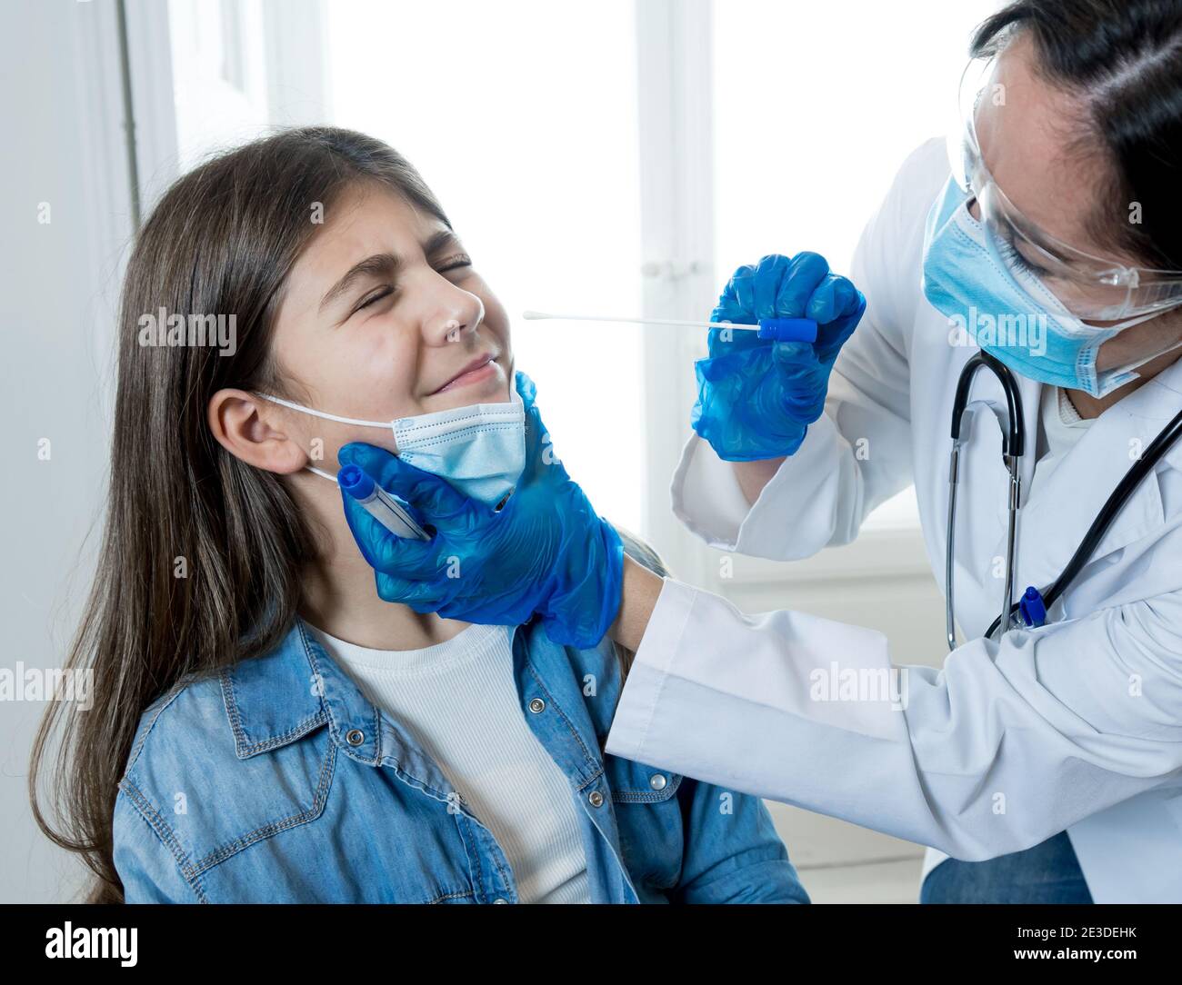 Nurse testing teen girl for coronavirus infection taking rapid COVID-19 ...