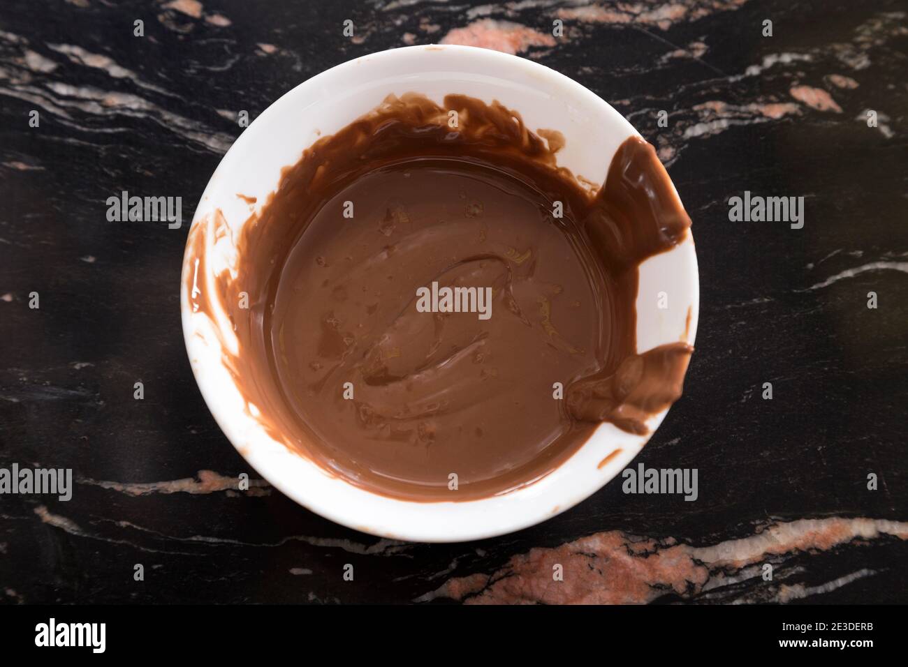 Melted hot chocolate in a white plastic bowl. Close-up Stock Photo - Alamy