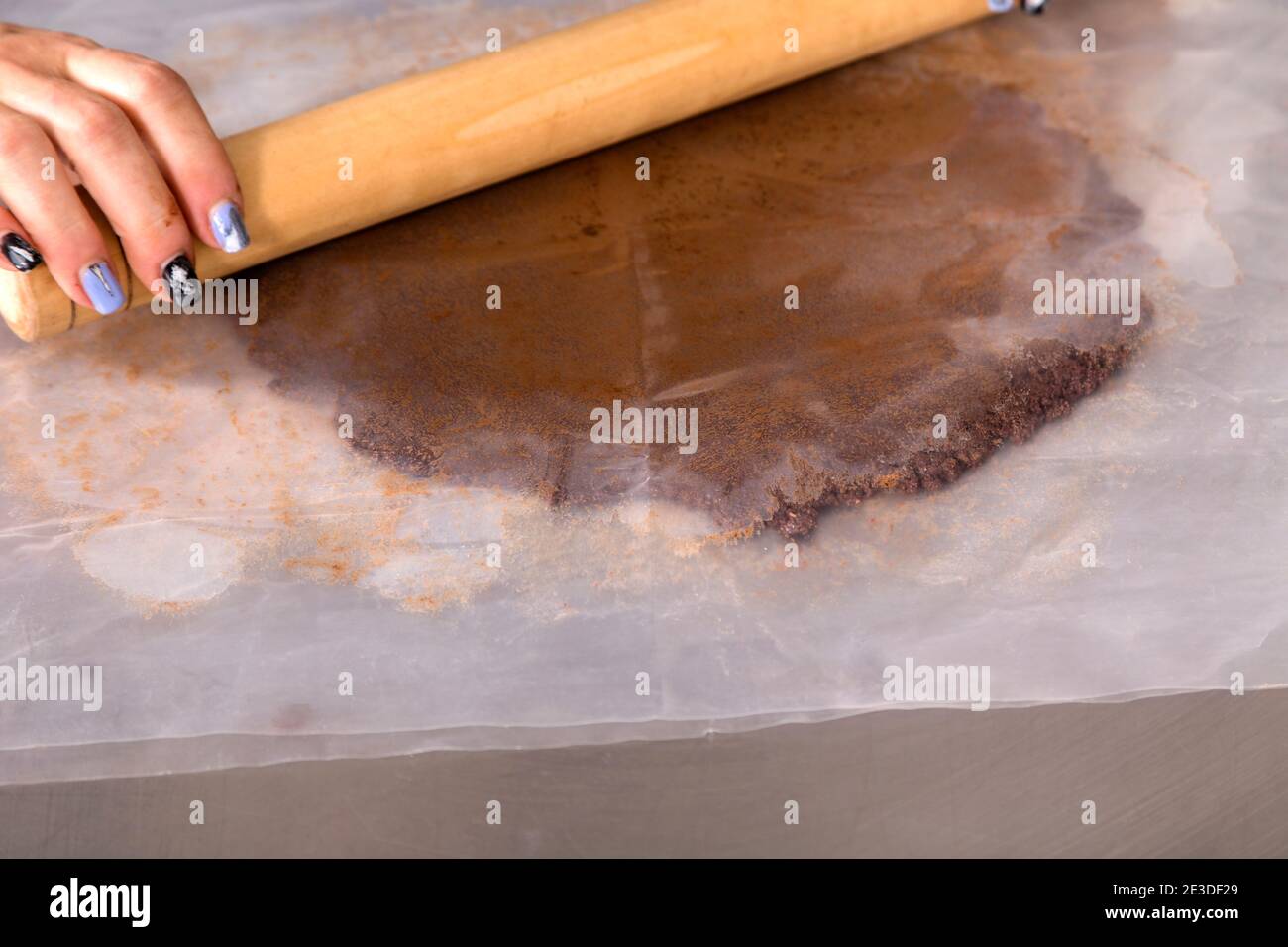 The process of making chocolate base for cake. Working with dough at ...