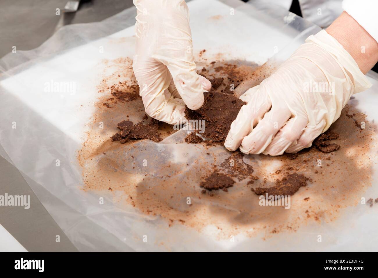 The process of making chocolate base for cake. Working with dough at ...