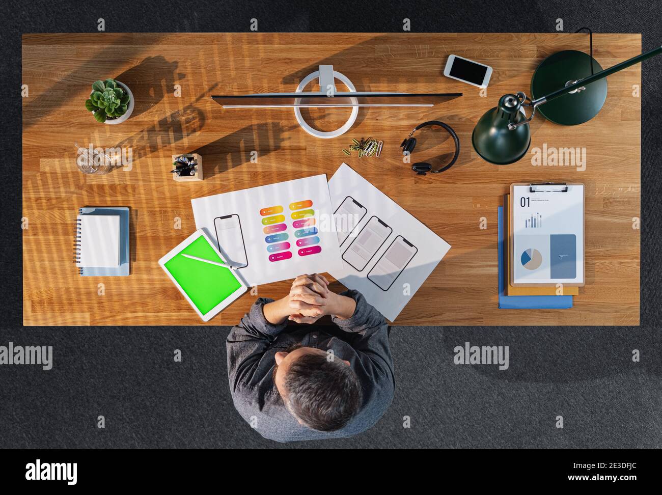 Top view of businessman working on computer at desk with keyable screen ...