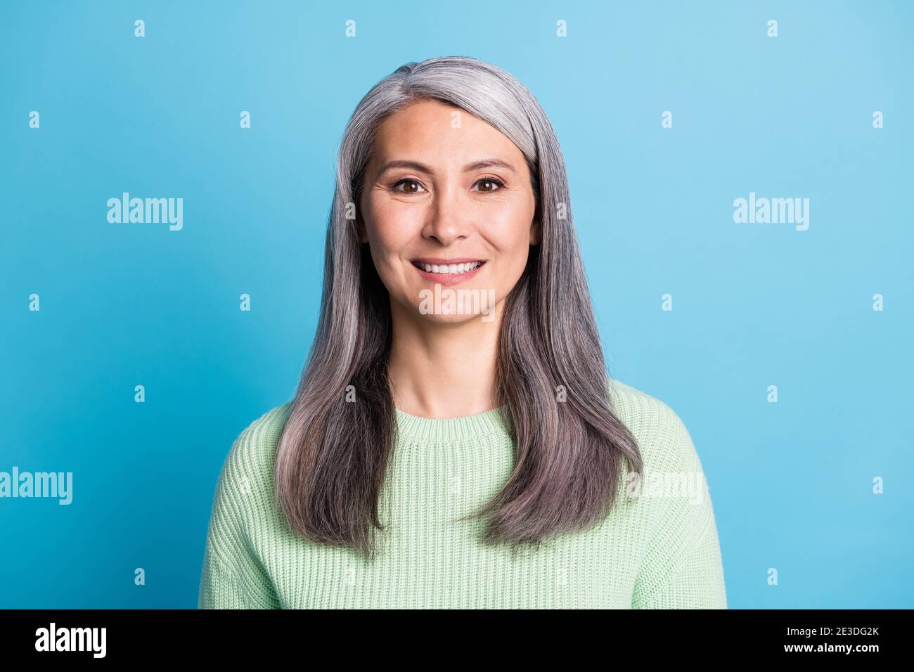 Photo of smiling happy aged nice lady dressed green pullover isolated ...