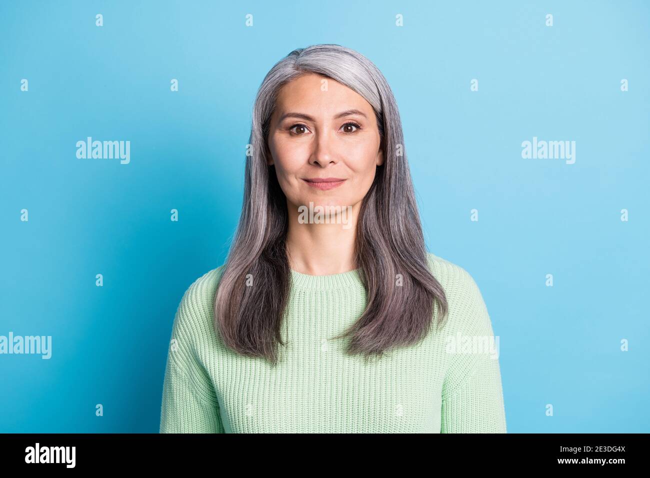 Portrait of cheerful happy aged mature nice lady dressed green pullover ...