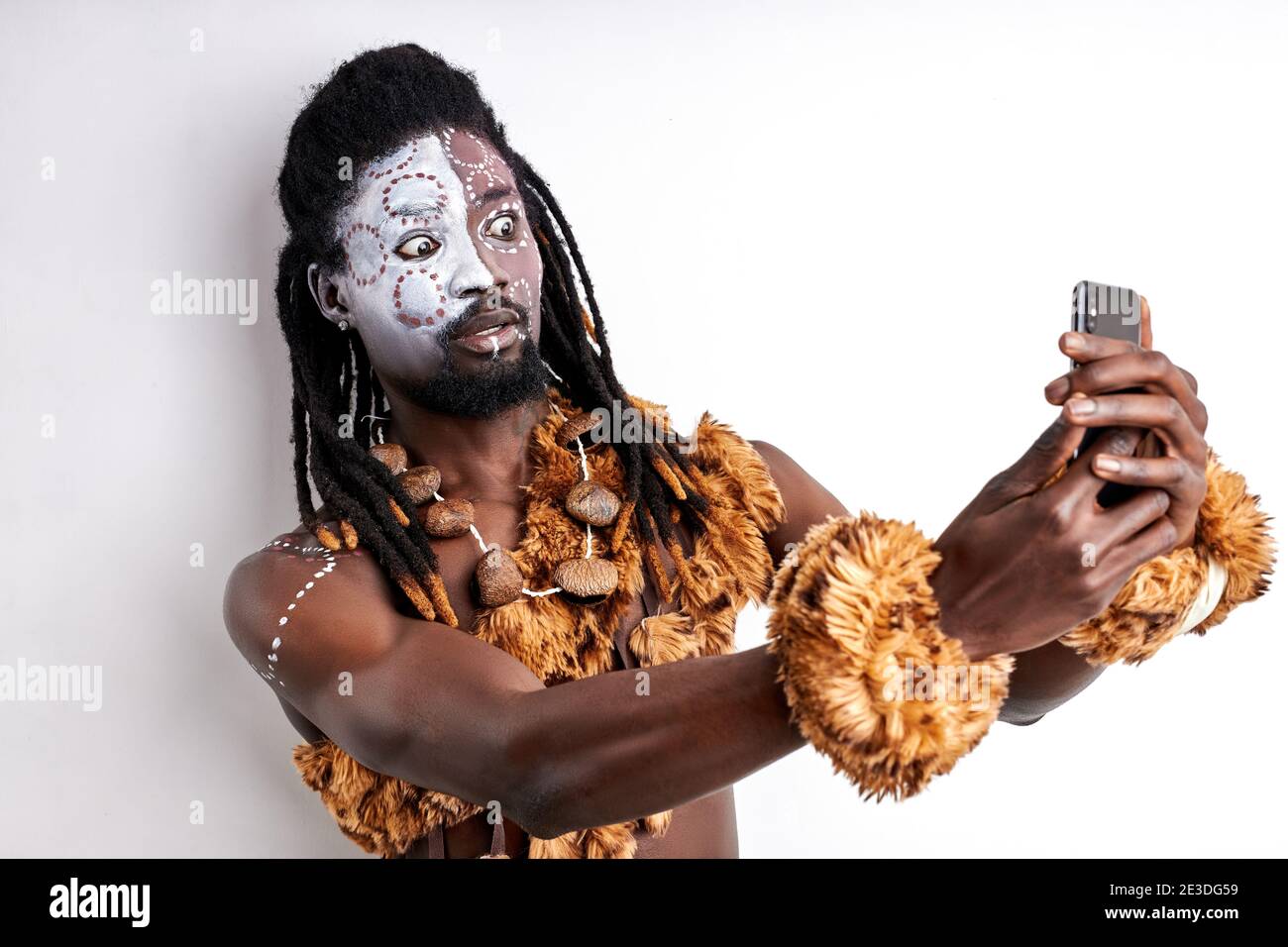 african primitive male using mobile phone, he is surprised by modern ...