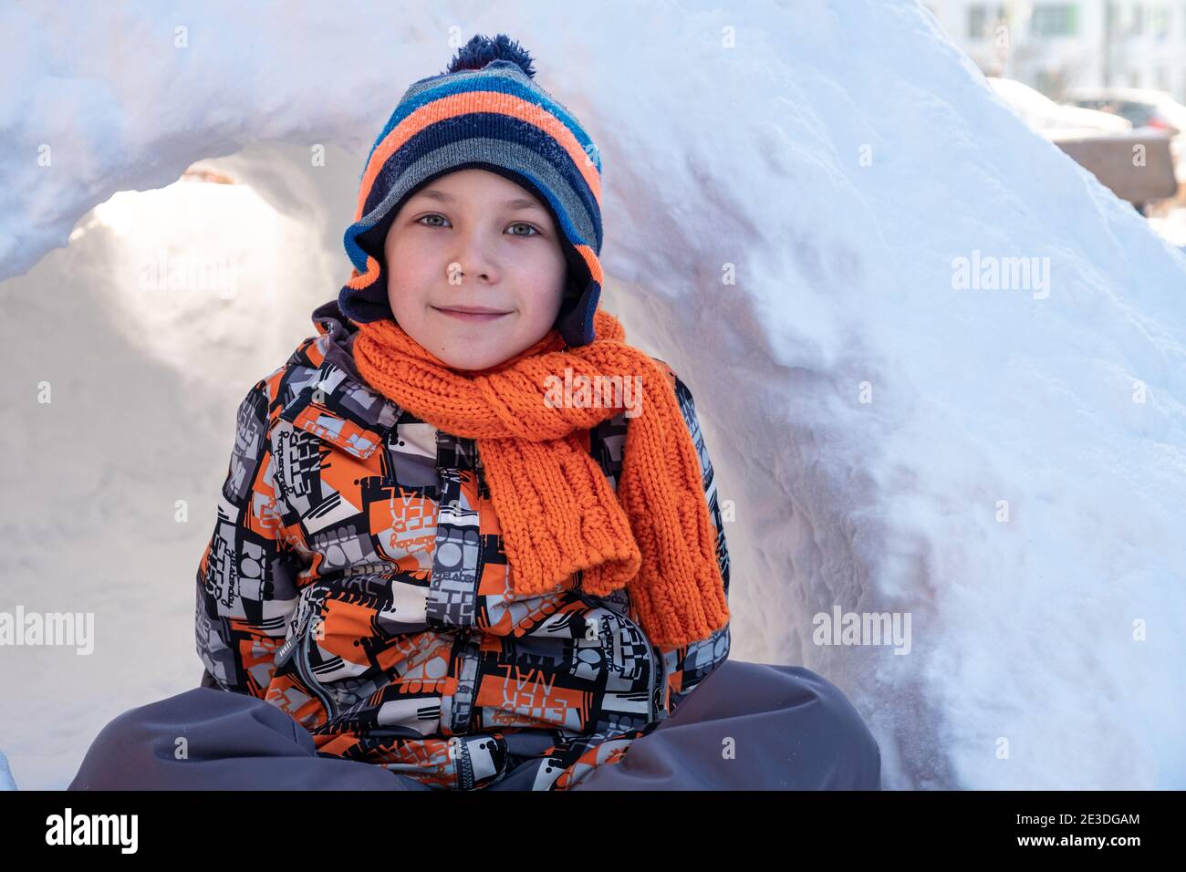 Cute boy playing in the snow castle igloo Stock Photo - Alamy