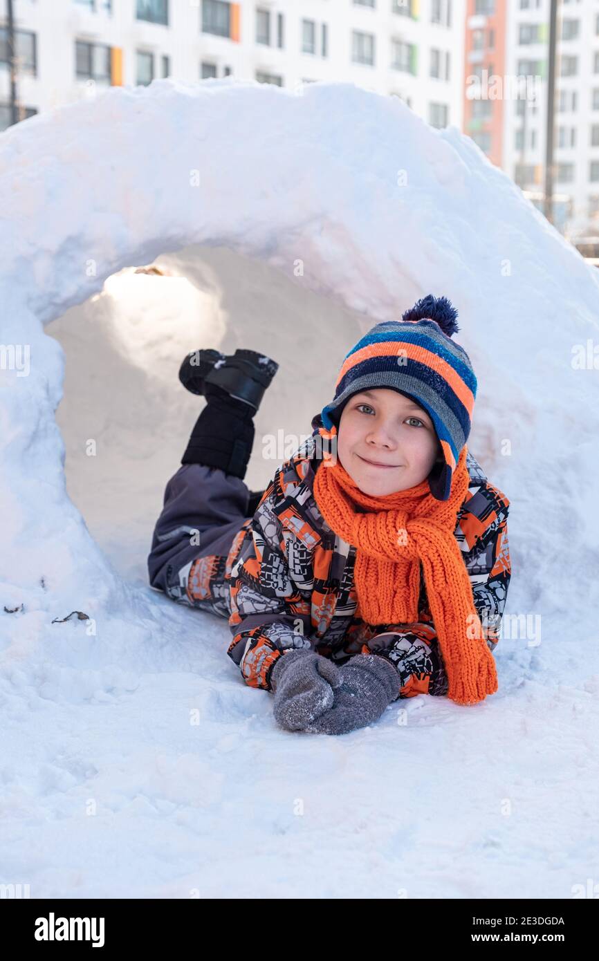 Cute boy playing in the snow castle igloo Stock Photo - Alamy