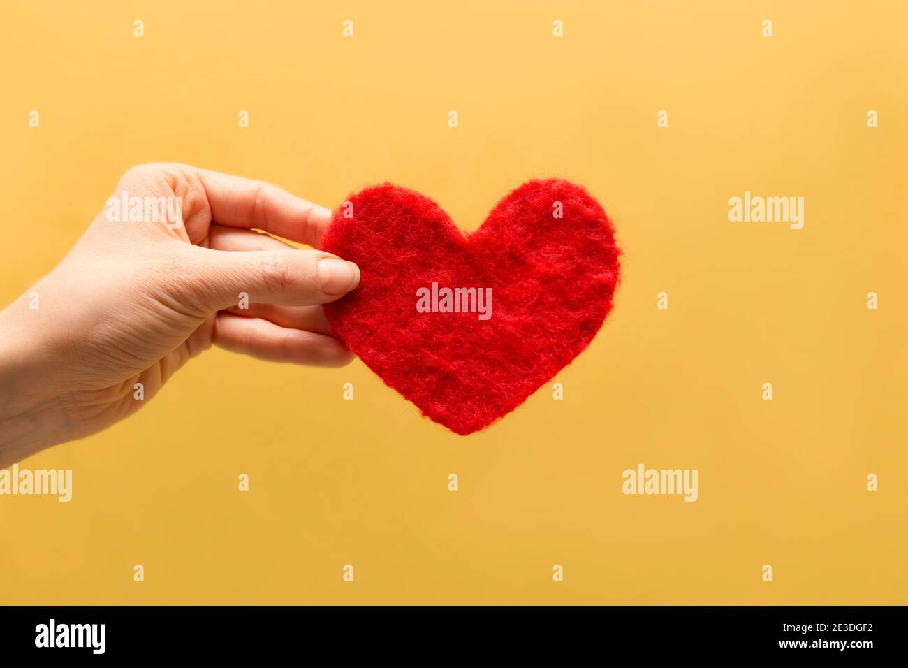 Red decorative heart in hand. Love symbol Stock Photo - Alamy