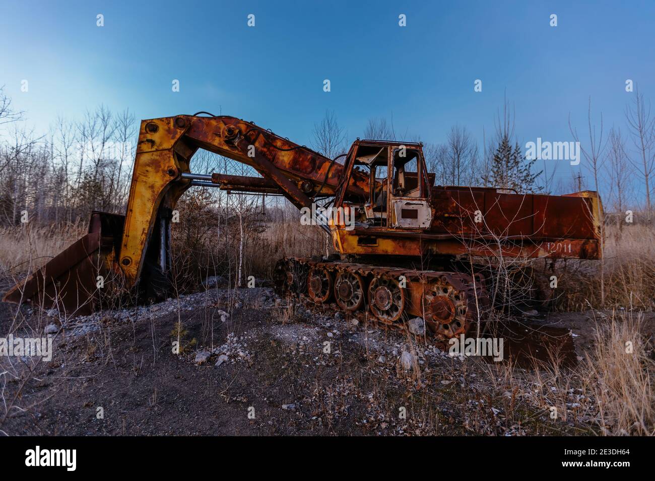 Old rusty abandoned excavator after closing of the factory Stock Photo ...