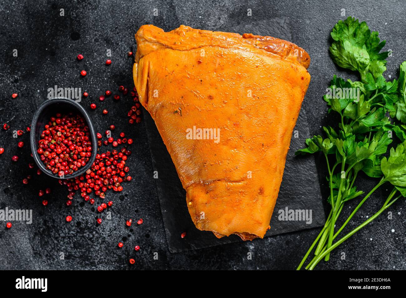 Raw pork leg with herbs and marinate on table. Black background. Top ...