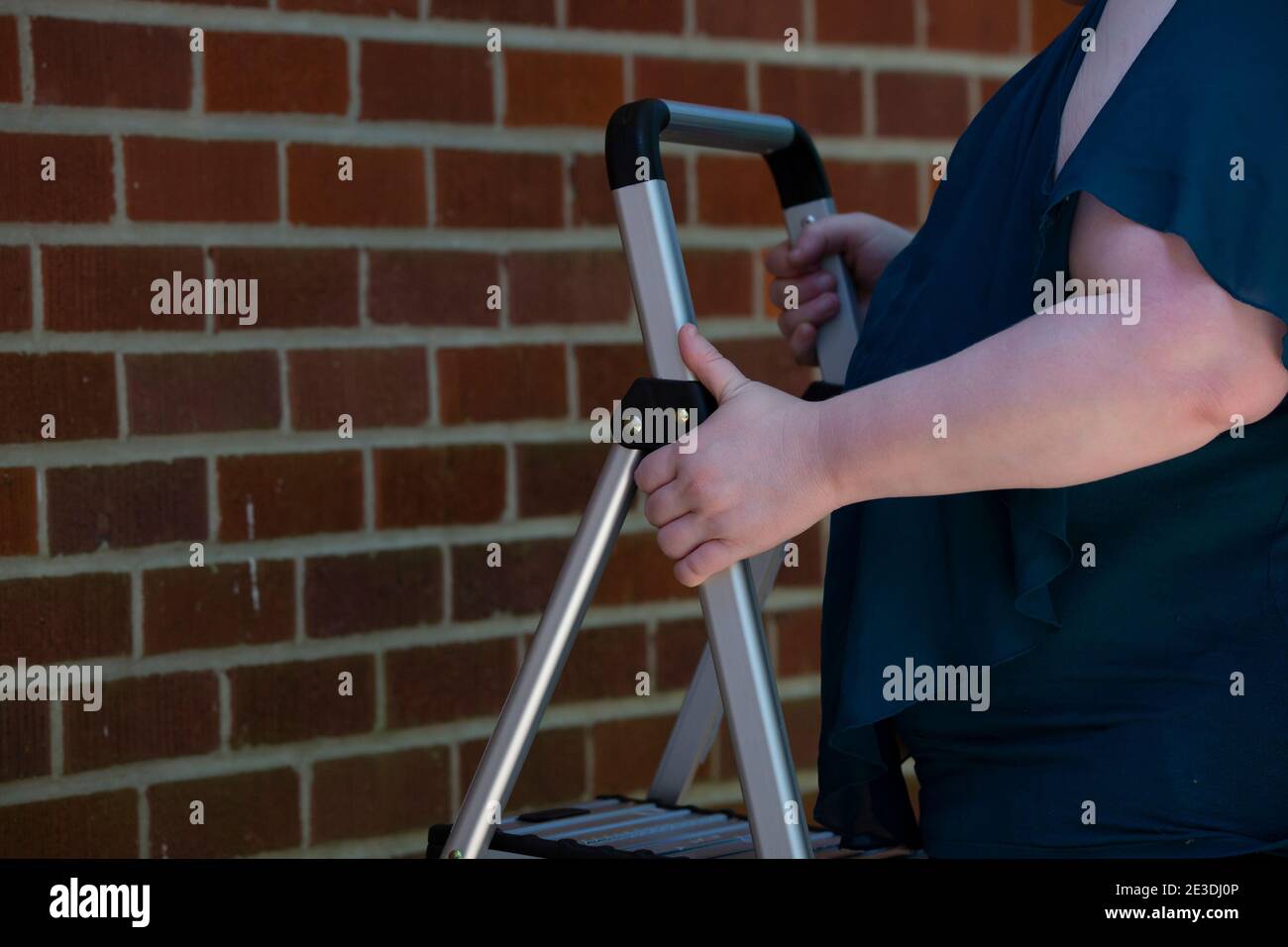 Woman climb ladder wall hi-res stock photography and images - Alamy