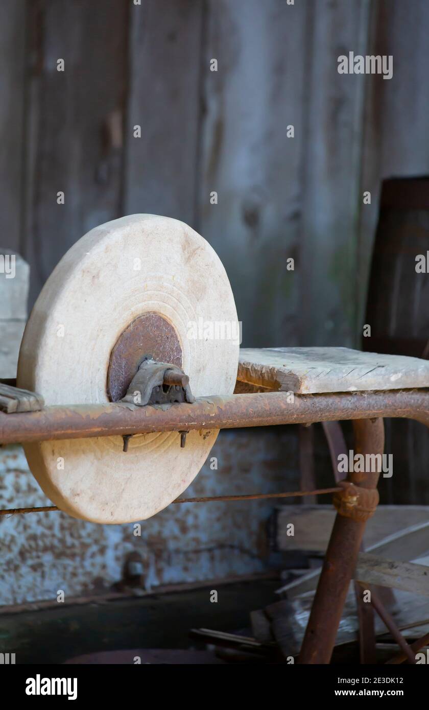 Old stone grinding machine on a wooden platform Stock Photo - Alamy