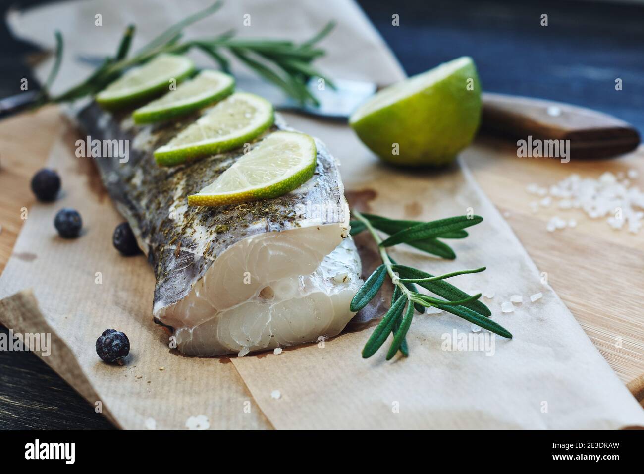 Raw fish with lemon slices and rosemary Stock Photo - Alamy
