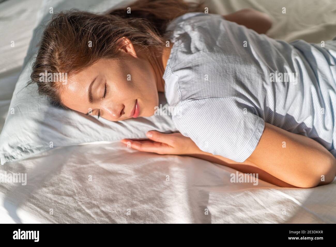 Bed Asian girl sleeping on stomach sleeper resting head on foam pillow ...