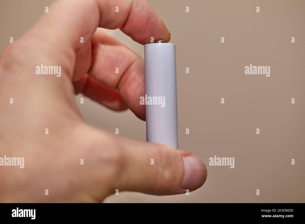 1.5 Volt AA Battery in hand Stock Photo - Alamy