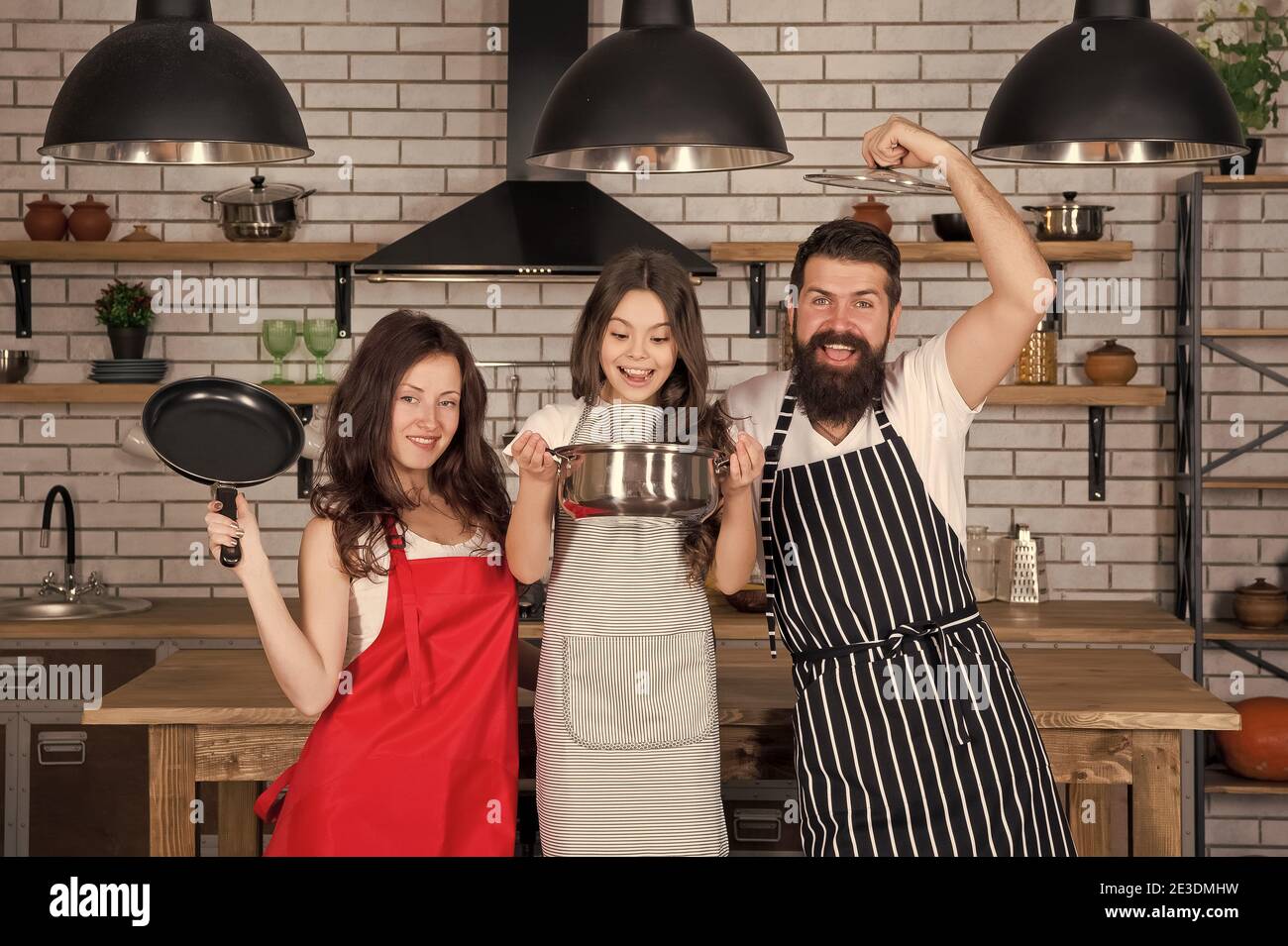 Mother and father cooking with daughter. happy family day. friendly ...