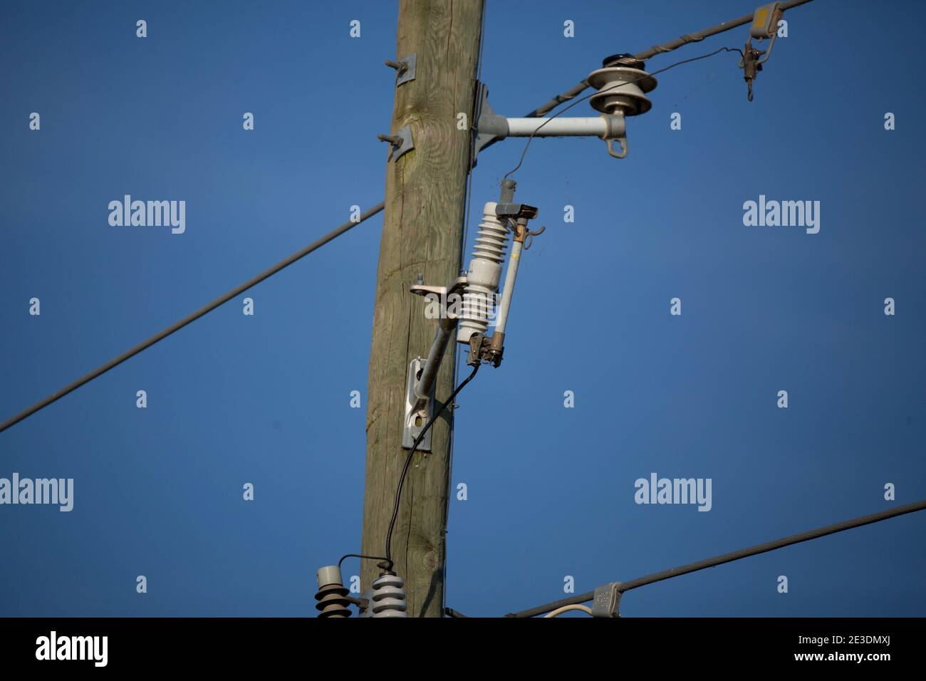 Electrical wires running through the sky, anchored by an electrical ...