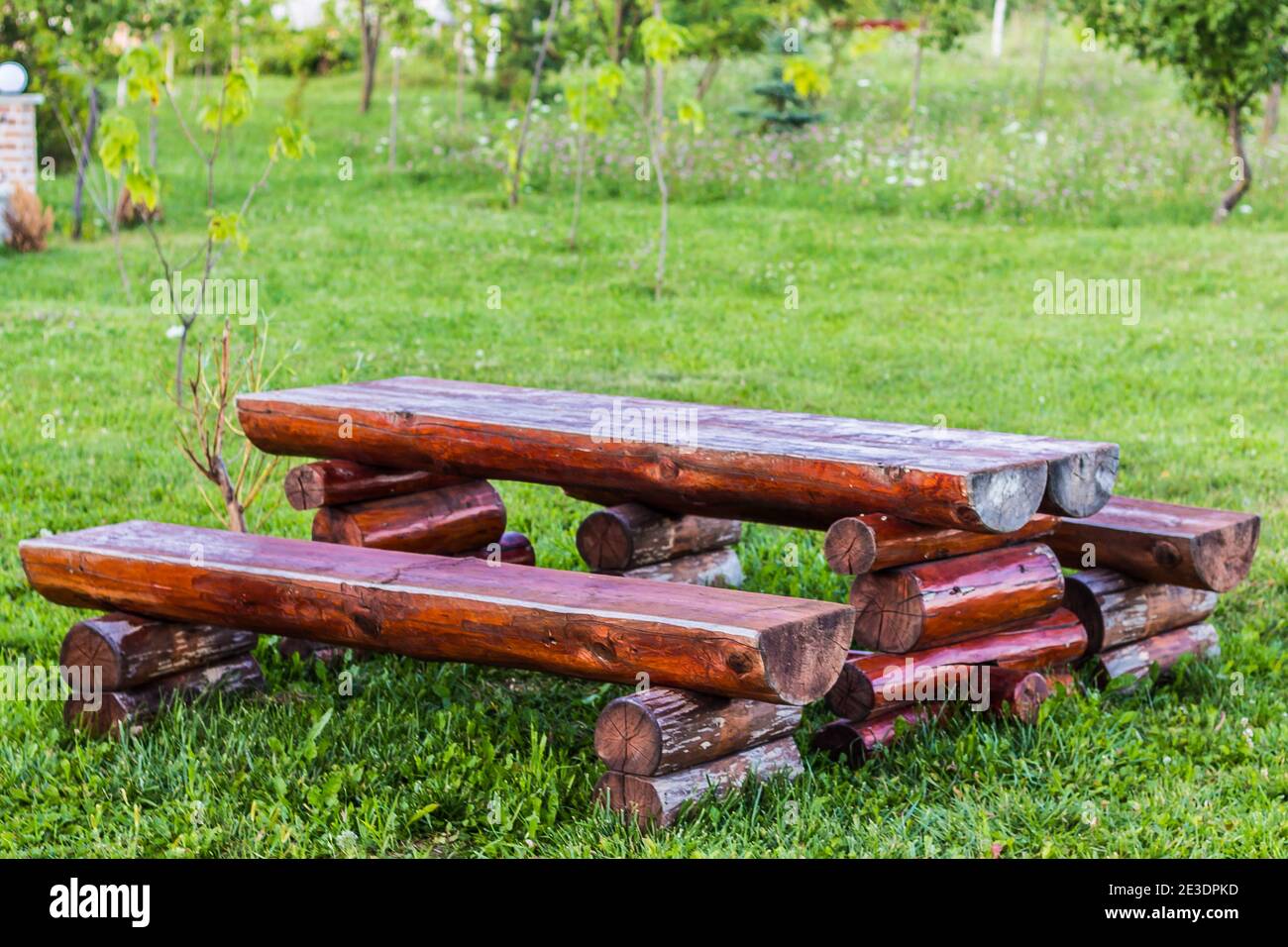 Garden table and benches made of wood logs Stock Photo - Alamy