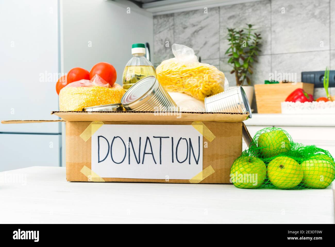 Open donation box with food in kitchen. Help for people. Charity ...