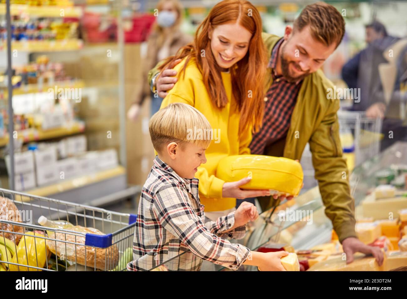family with child boy in grocery store, family in shop. Parent and ...