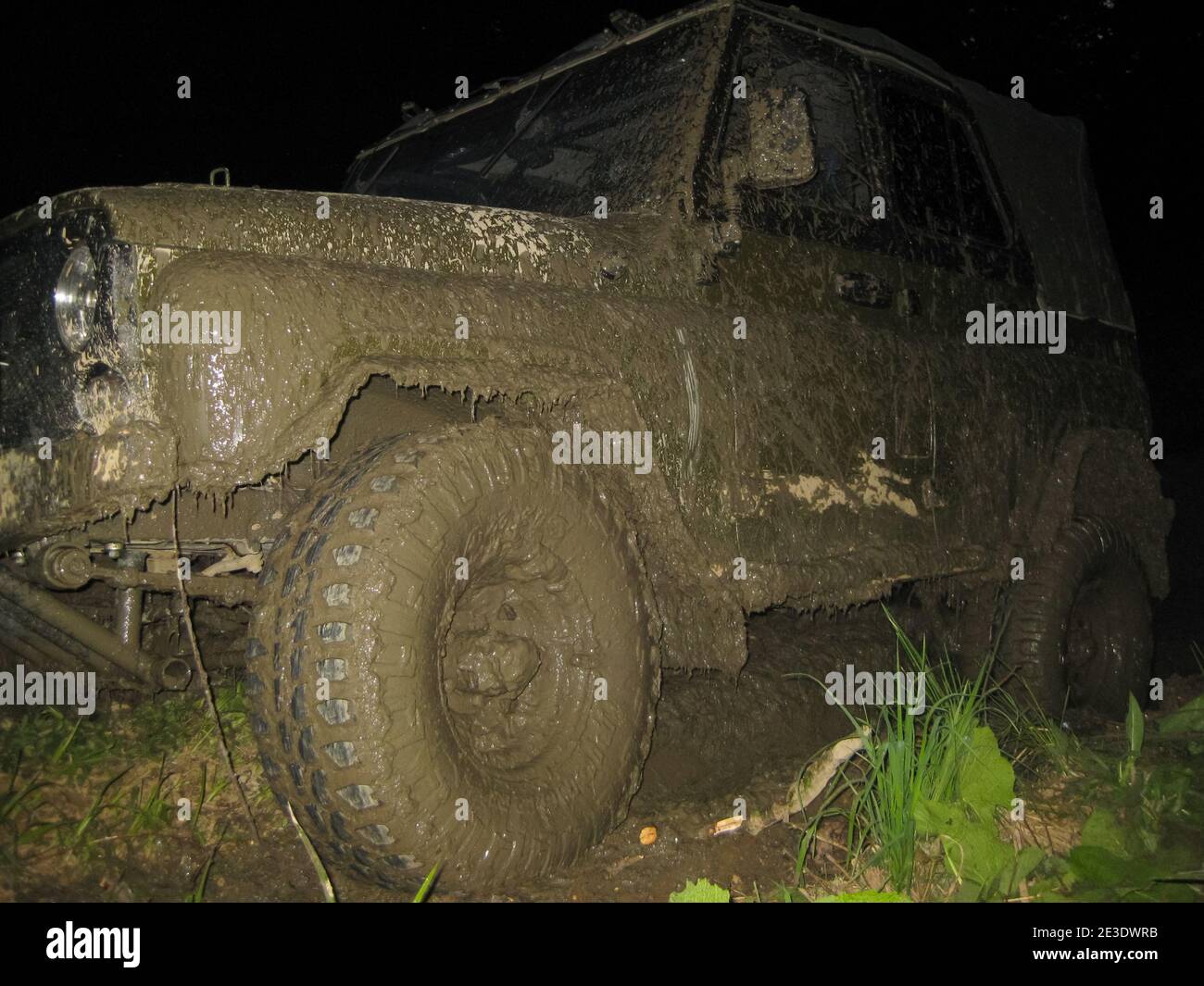 It's a very dirty car. The SUV is driving through the mud Stock Photo ...
