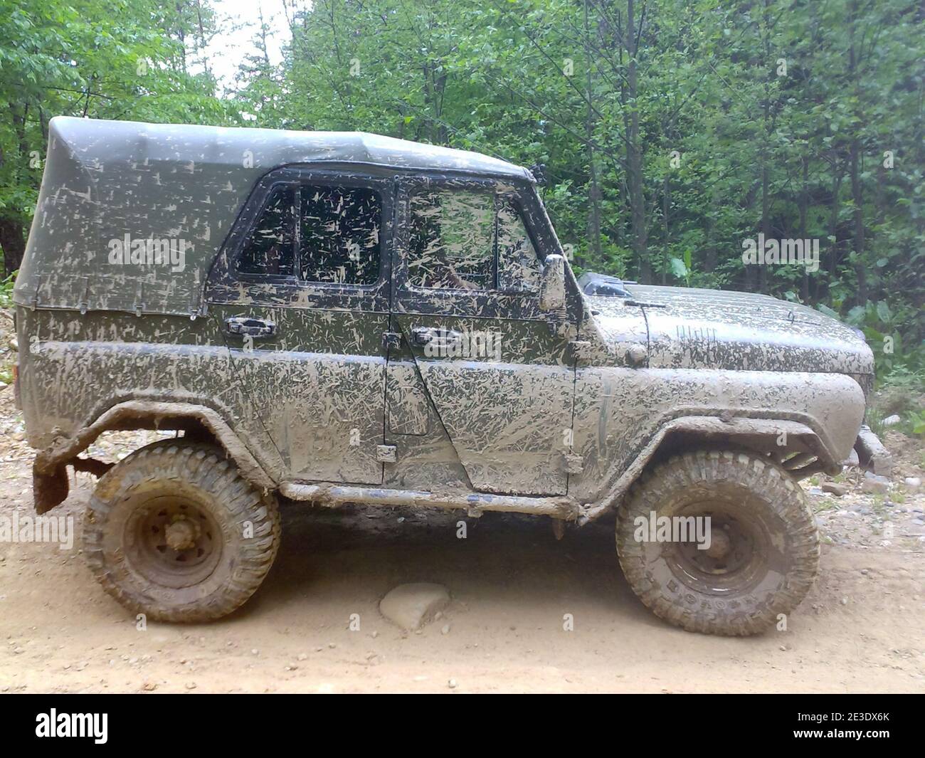 It's a very dirty car. The SUV is driving through the mud Stock Photo ...
