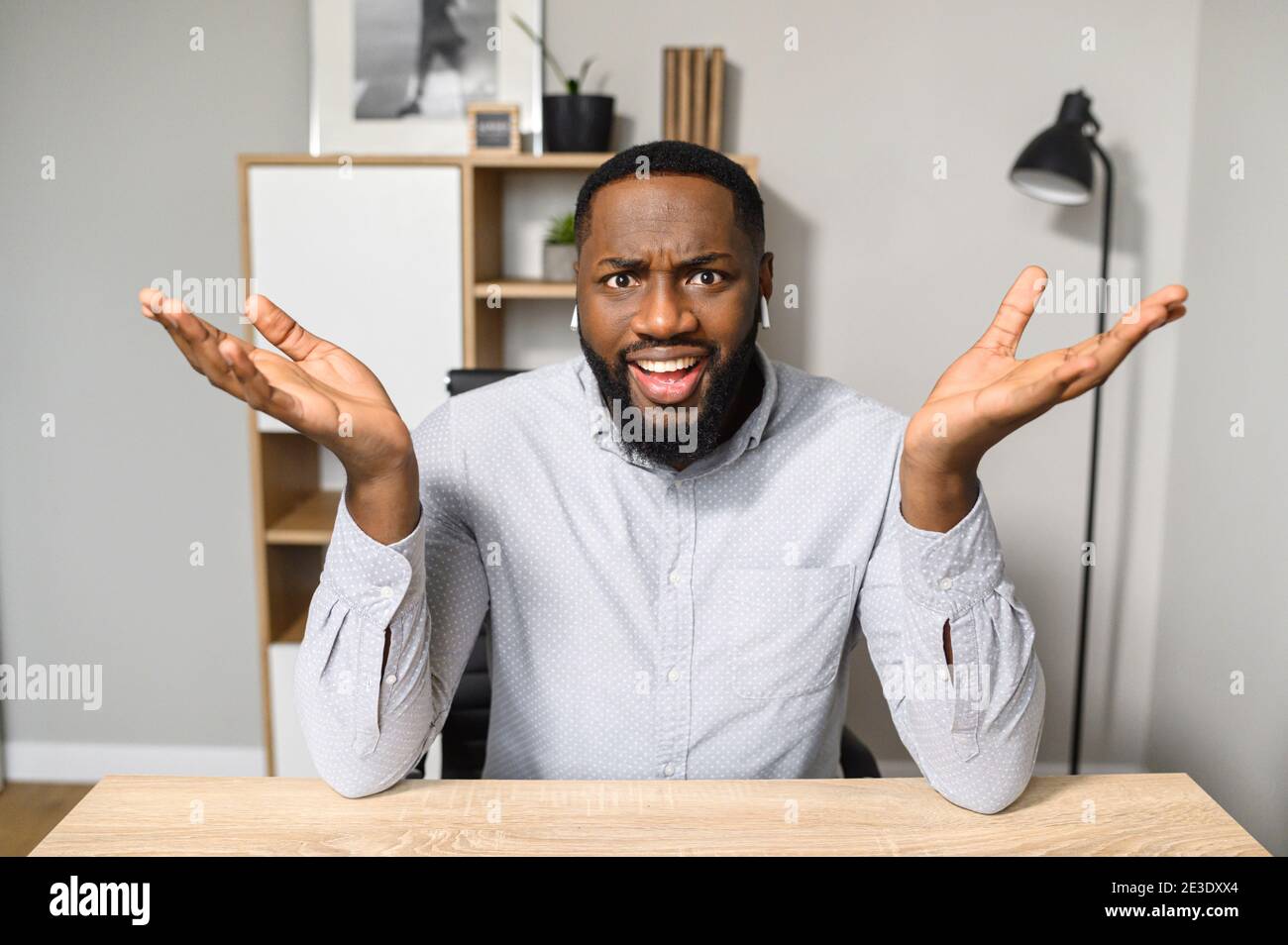 Frustrated African American worker raising hands up Stock Photo - Alamy