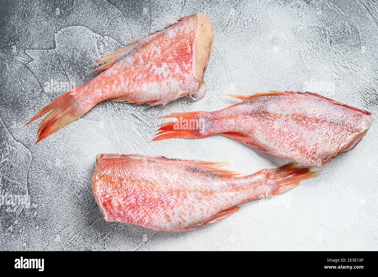 Raw Red perch or seabass fish. White background. Top view Stock Photo ...